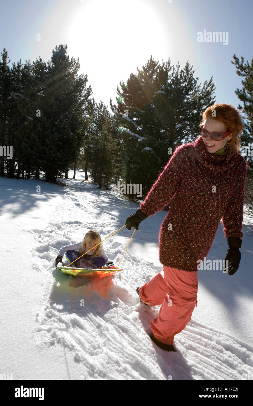Woman pulling daughter on sled hi-res stock photography and images - Alamy