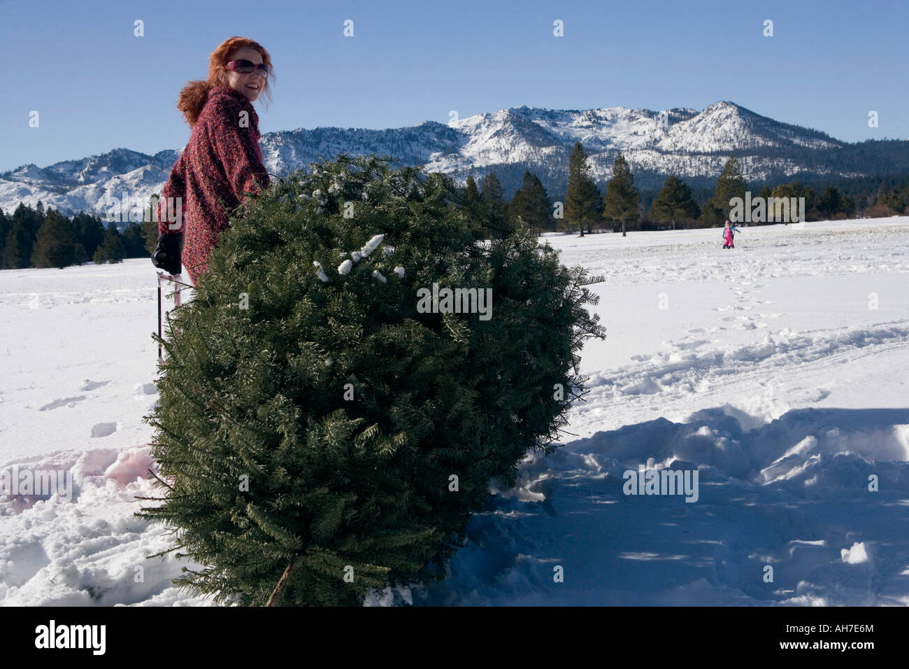 Mature woman standing by a tree Stock Photo - Alamy