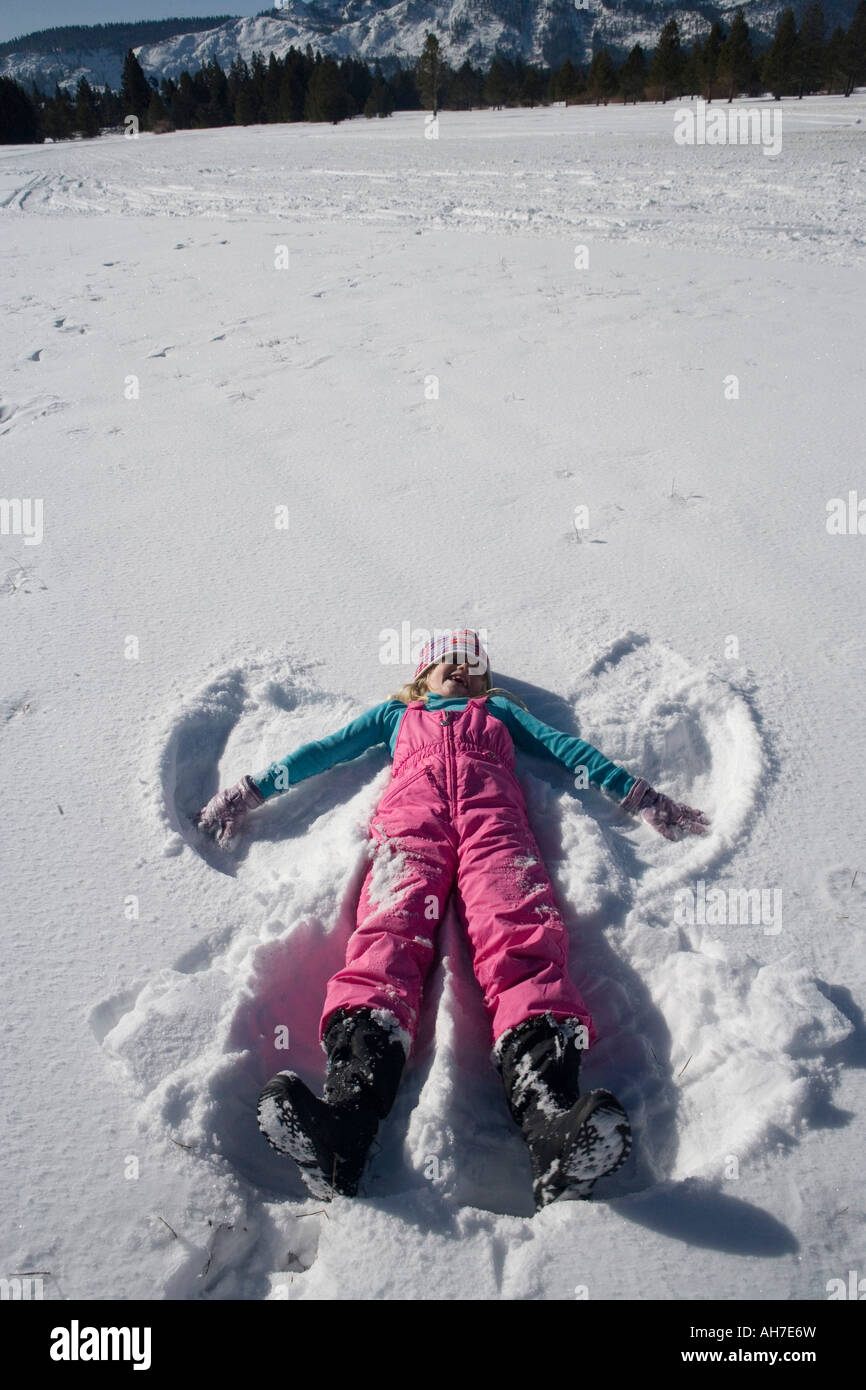 High angle view of a girl making a snow angel Stock Photo - Alamy