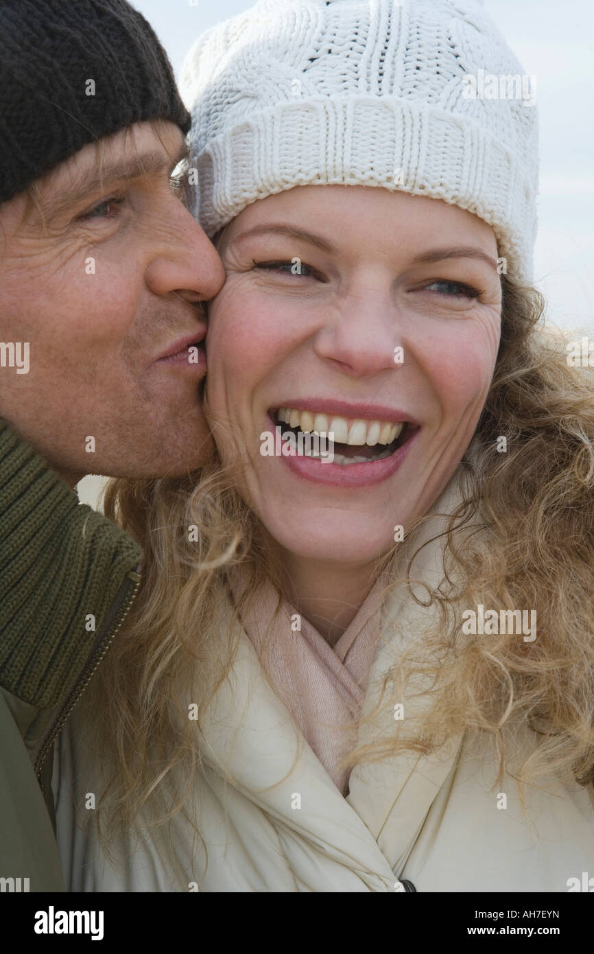 Mid adult man kissing a mid adult woman Stock Photo - Alamy