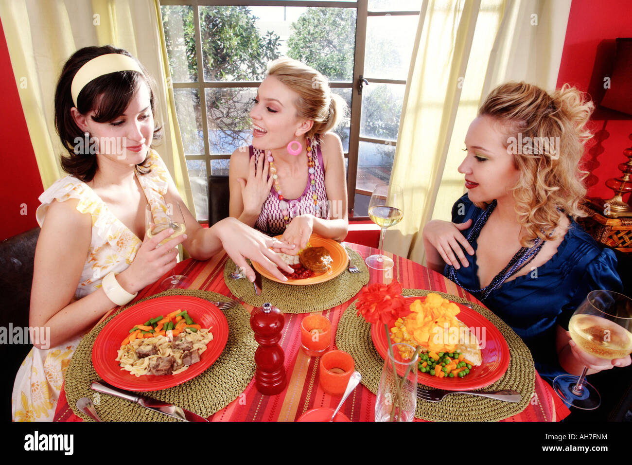 Three young woman dining in a restaurant Stock Photo - Alamy