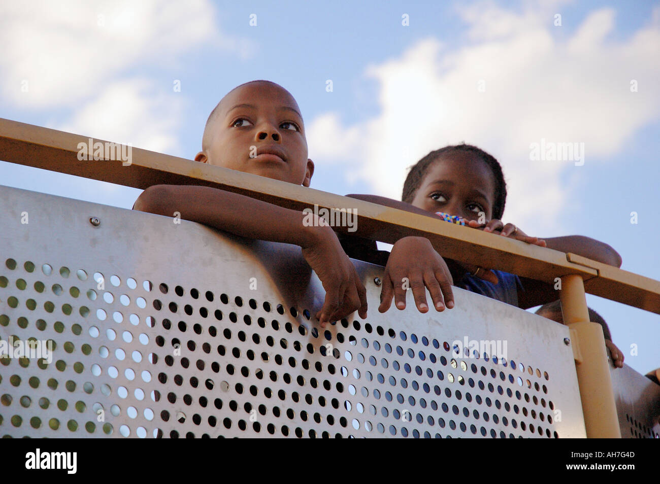 Young black children looking over railing London Stock Photo - Alamy