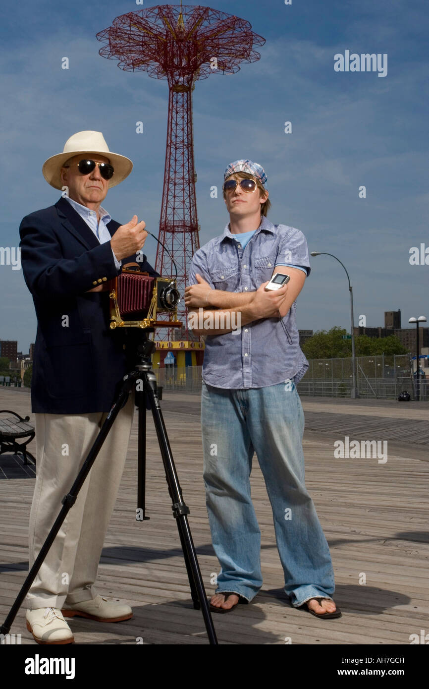 Senior man and a young man holding cameras, Parachute Drop, Coney ...