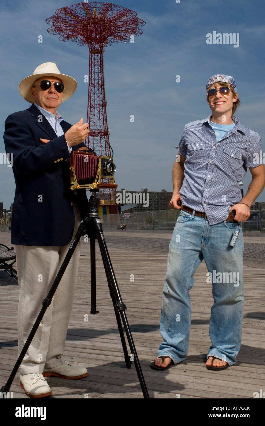 Young man standing beside a senior man with a camera, Parachute Drop ...