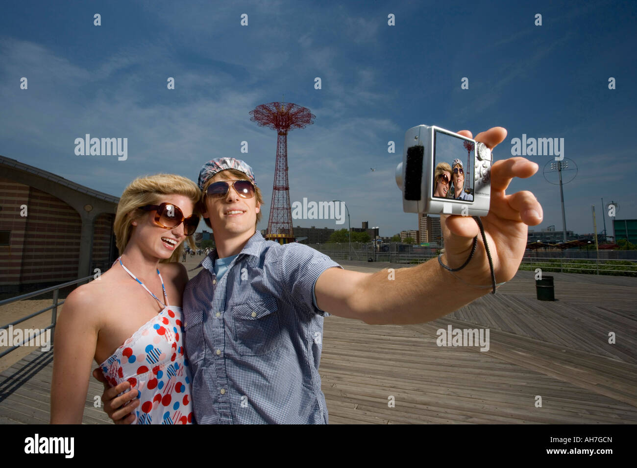 Young couple taking a photograph with a digital camera, Parachute Drop ...