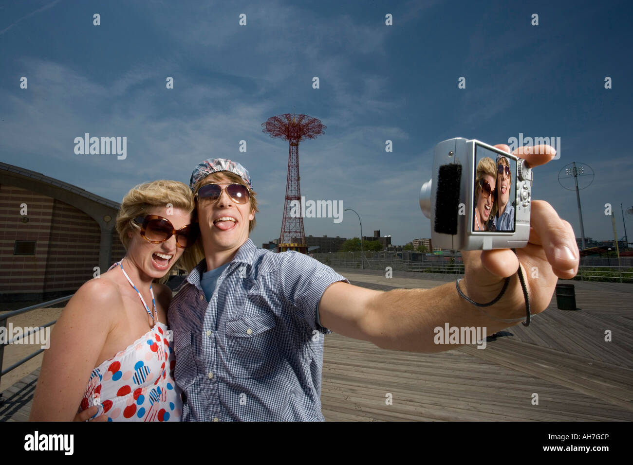Young couple taking a photograph with a digital camera, Parachute Drop ...