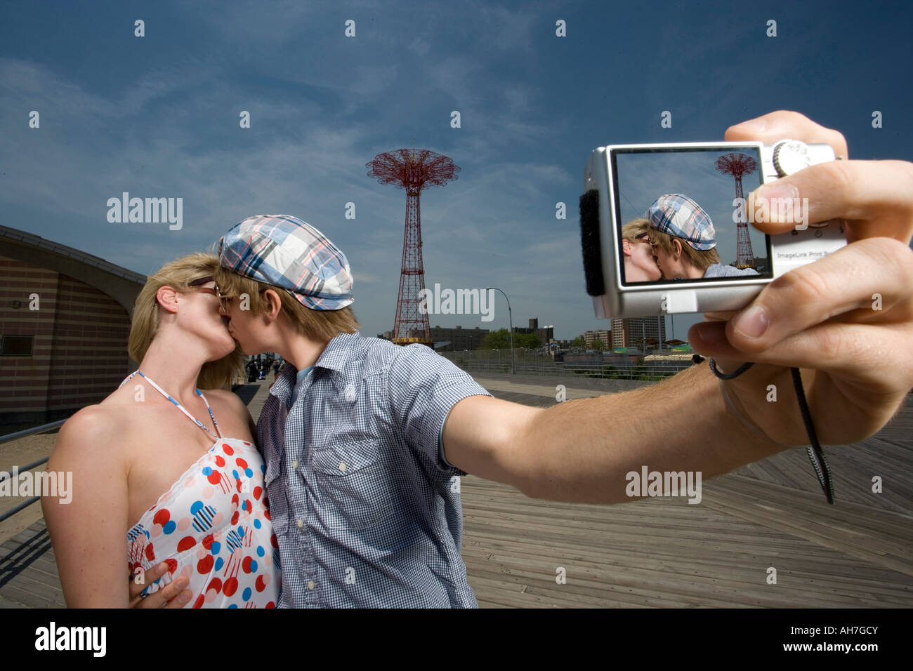 Young couple taking a photograph with a digital camera, Parachute Drop ...