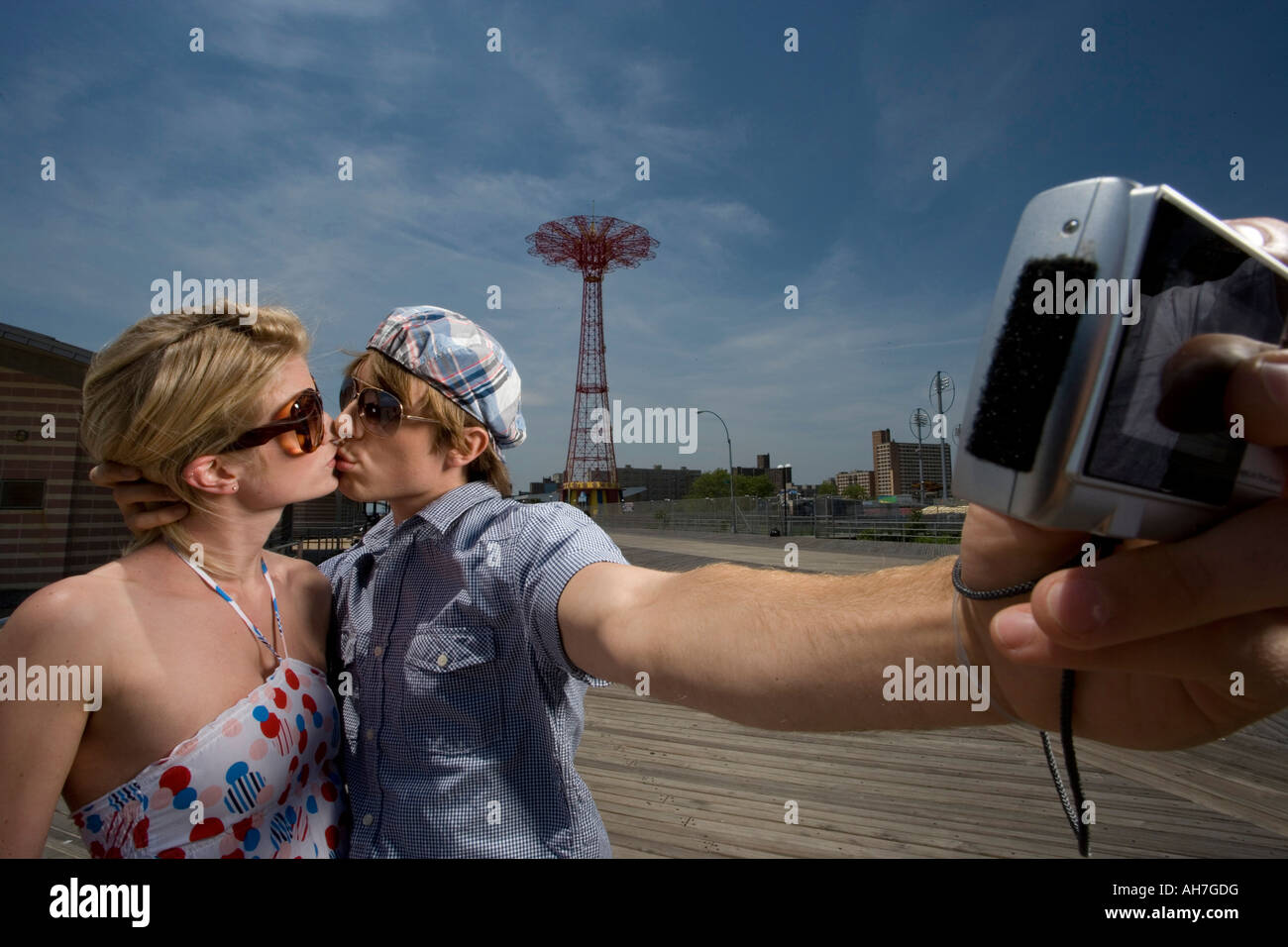 Young couple taking a photograph with a digital camera, Parachute Drop ...
