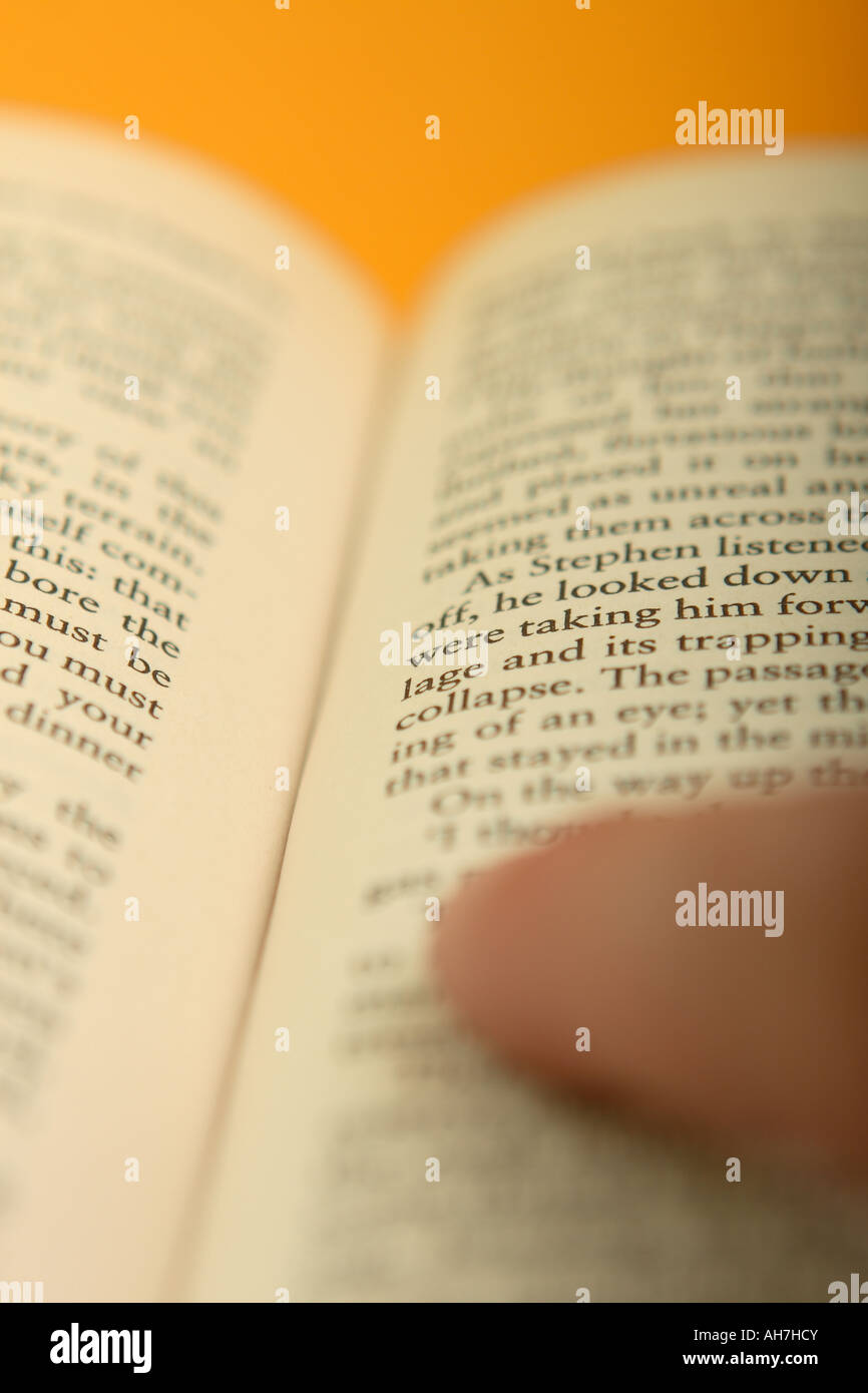 Reading a paperback book novel Stock Photo - Alamy