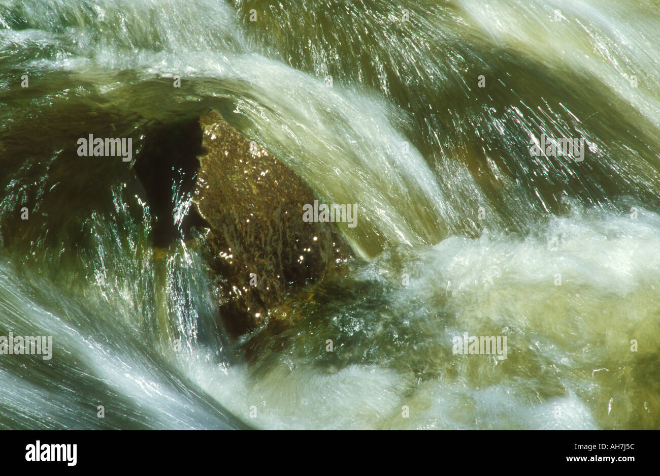 Tumbling rushing water in boulder strewn river Stock Photo - Alamy