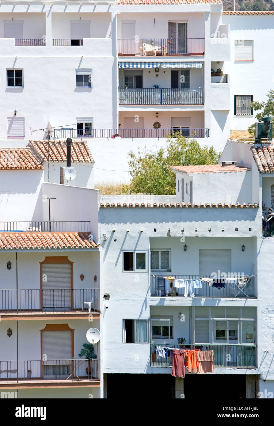 Windows of white Spanish pueblo wish washing lines and satellite dishes ...