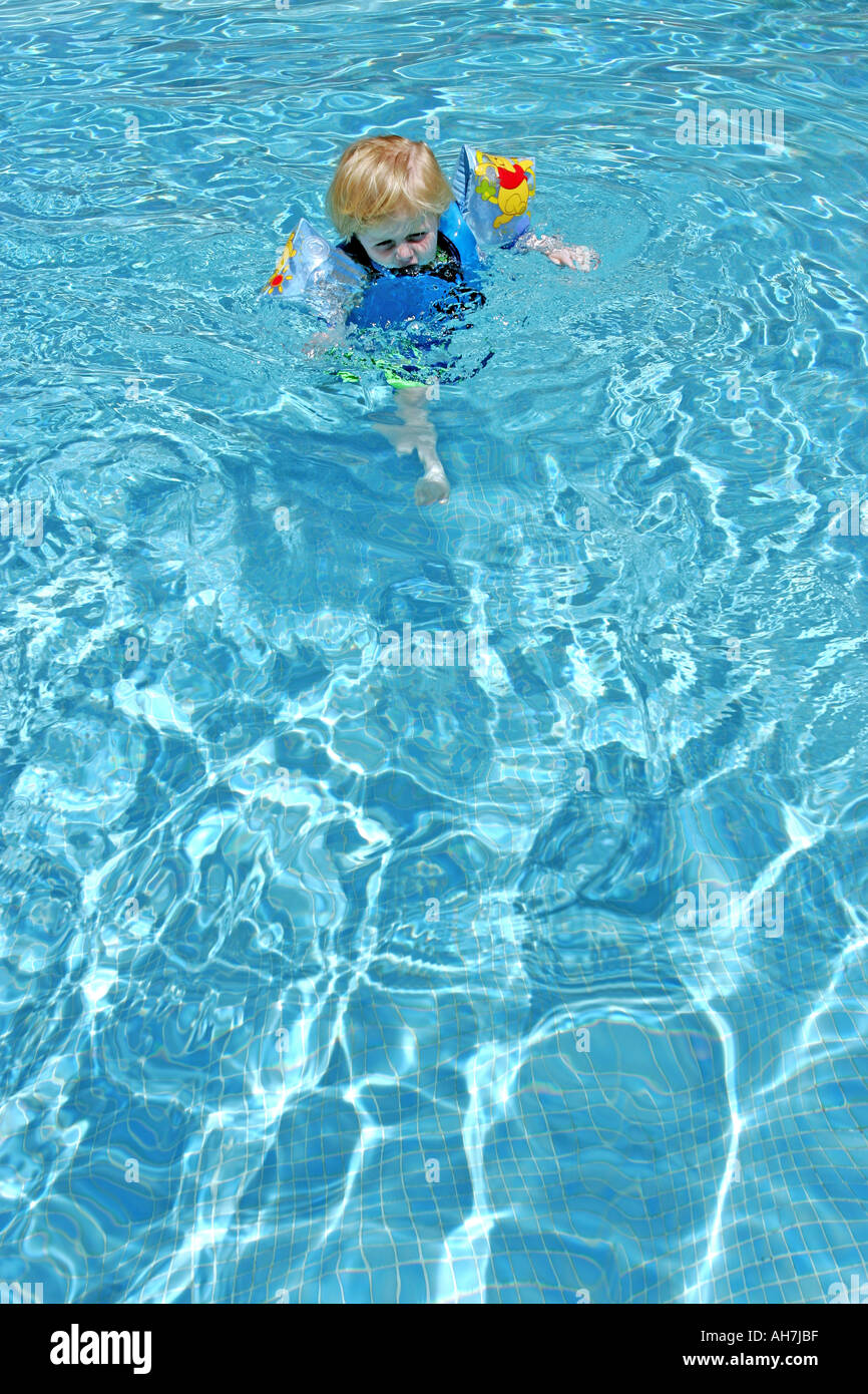 Young boy learning to swim in swimming pool Stock Photo - Alamy