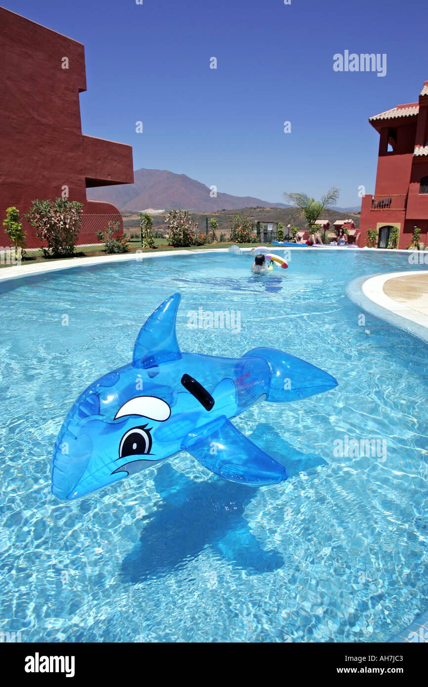 Inflatable blue dolphin in bright sunny swimming pool Stock Photo - Alamy
