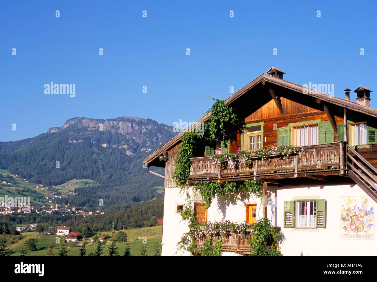 Traditional South Tirolean house below Siusi village with Alpe di Siusi ...