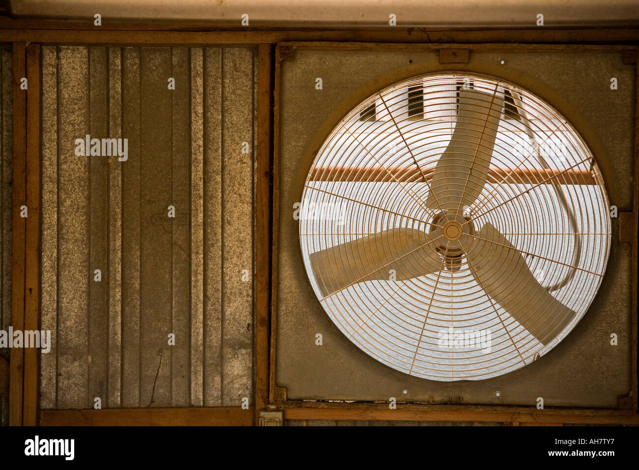 Rustic window fan in an old garage Stock Photo - Alamy