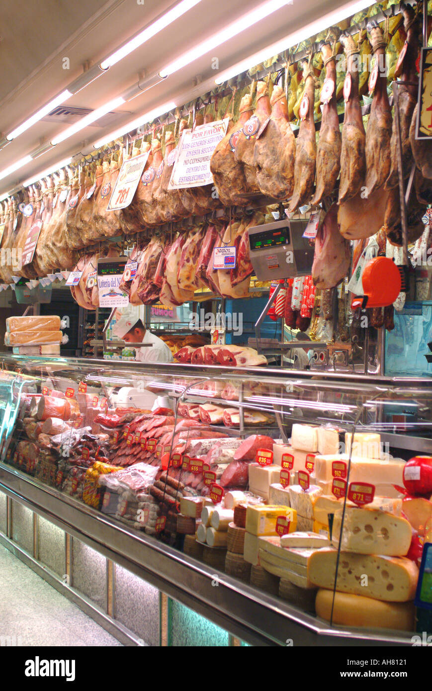 Cured Serrano jamon ham hanging in Spanish tapas bar Stock Photo - Alamy
