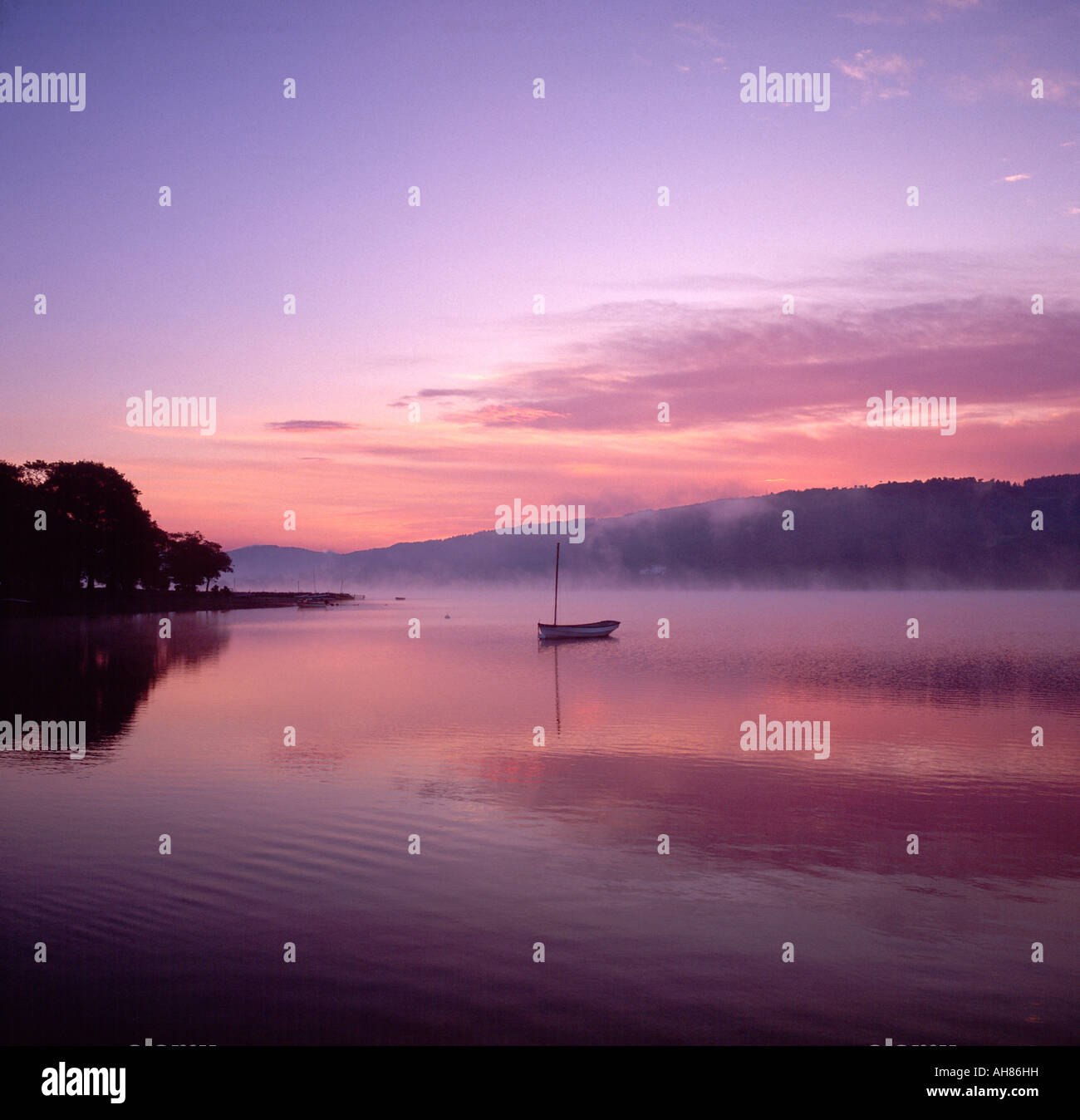 Pink dawn over Coniston with mist and sailing boat Stock Photo - Alamy
