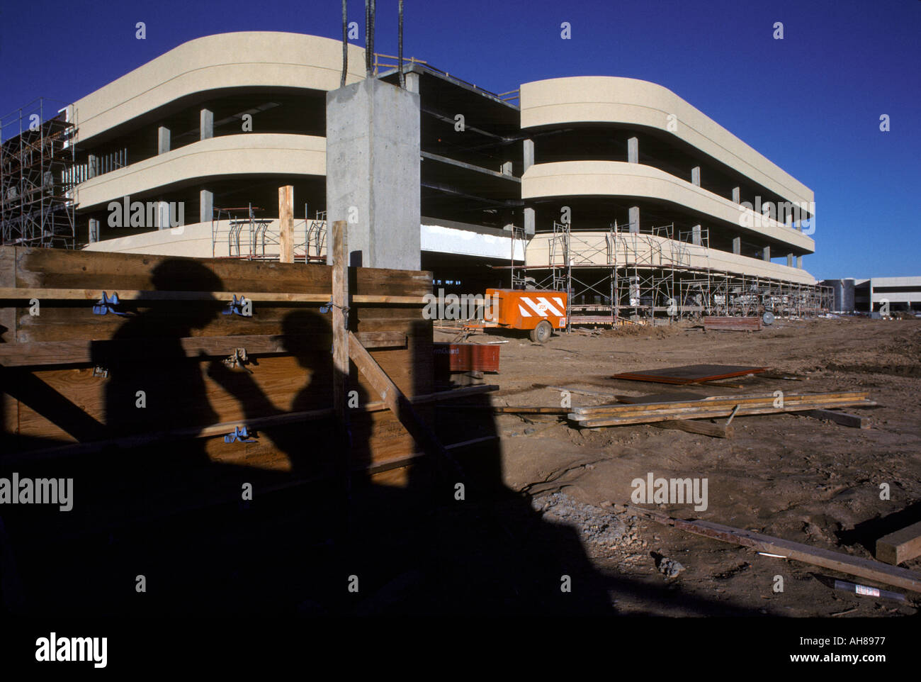 Office building construction site with shadows of workers Stock Photo ...