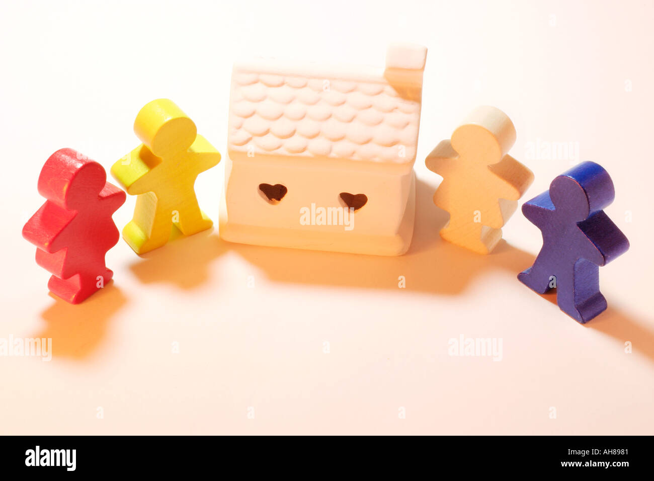 Wooden Children Figurines and Miniature House Stock Photo - Alamy