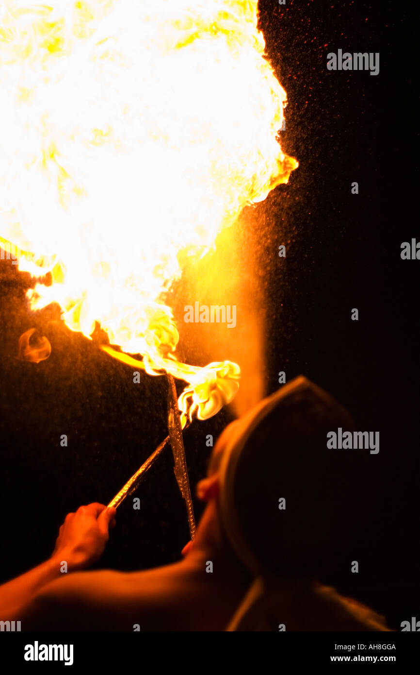 Fire breathing performer breathes flames Stock Photo - Alamy
