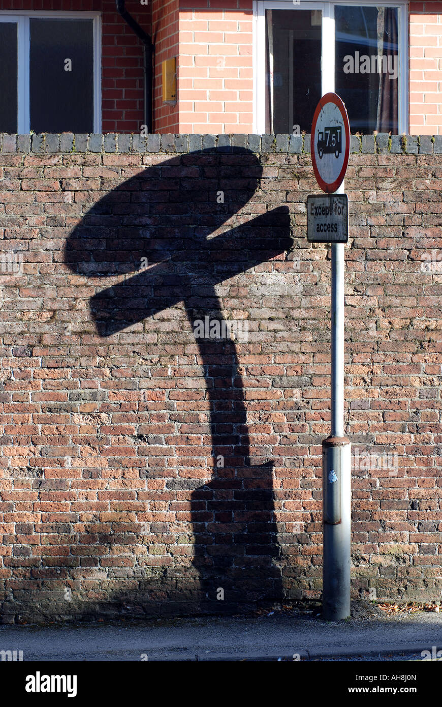 Shadow of road sign on wall, Ashbourne, Derbyshire, England, UK Stock ...