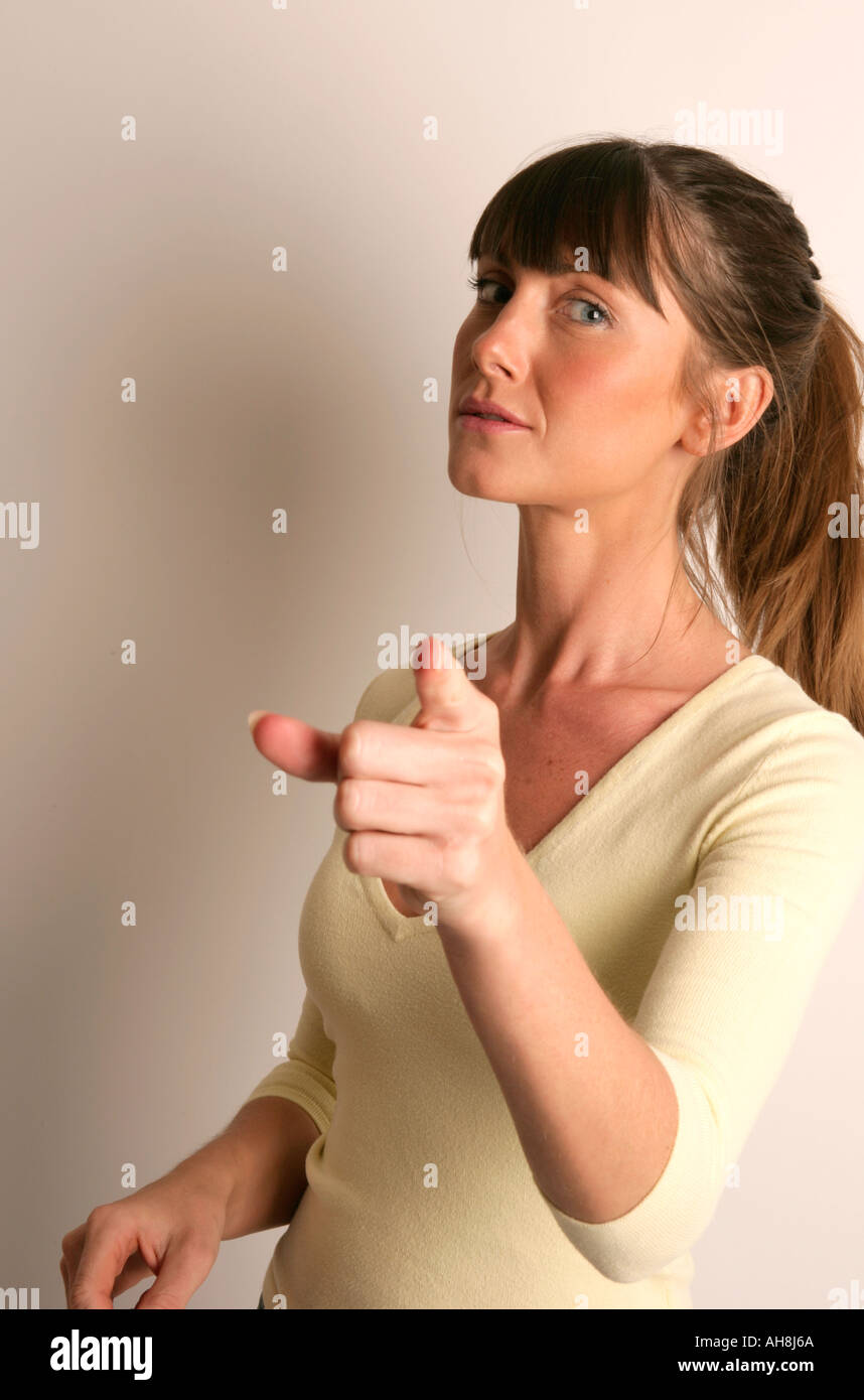 Woman pointing with a look of concern fear or intimidation Stock Photo ...