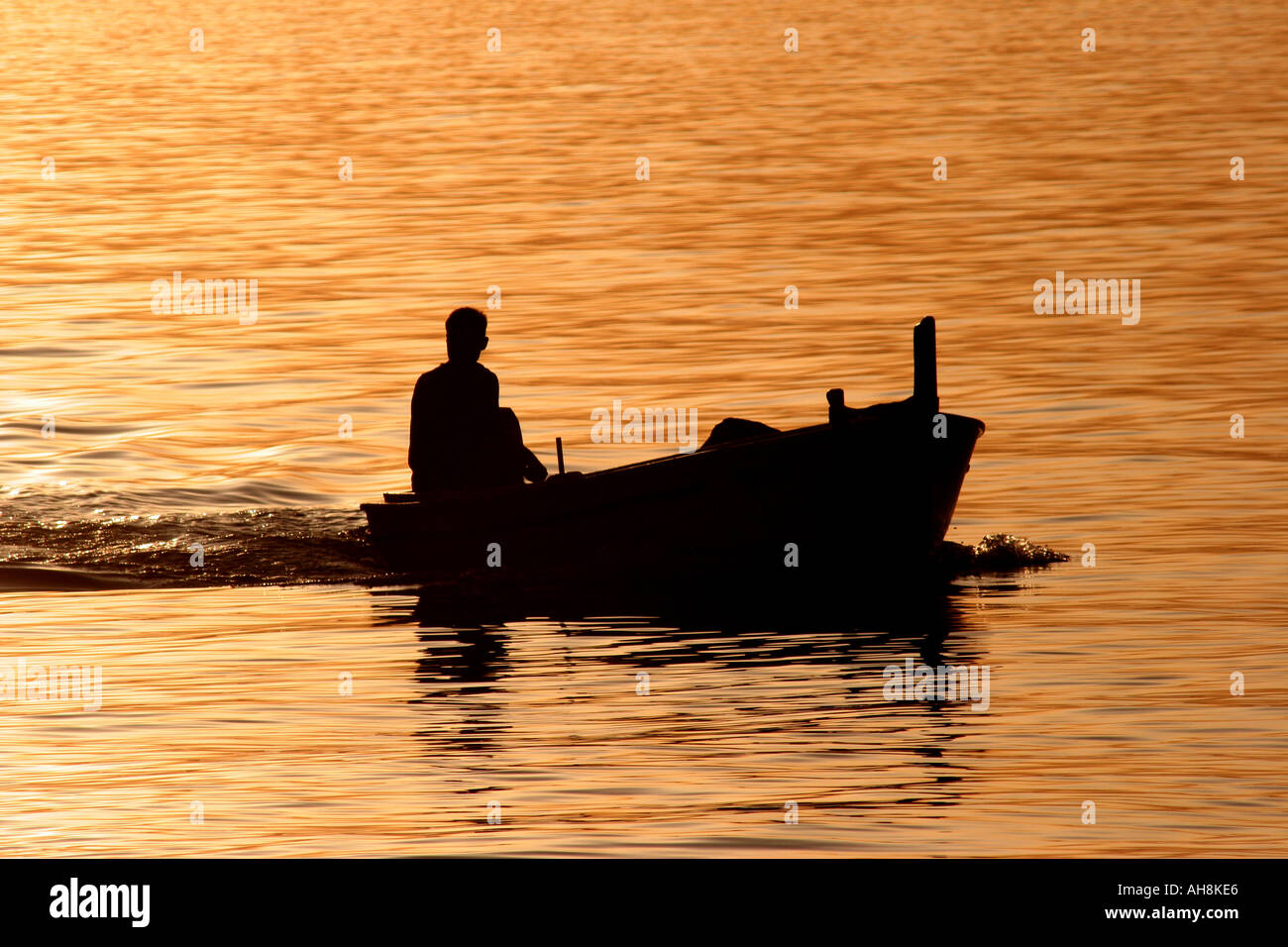 Fishing boat returning harbour sunset hi-res stock photography and ...