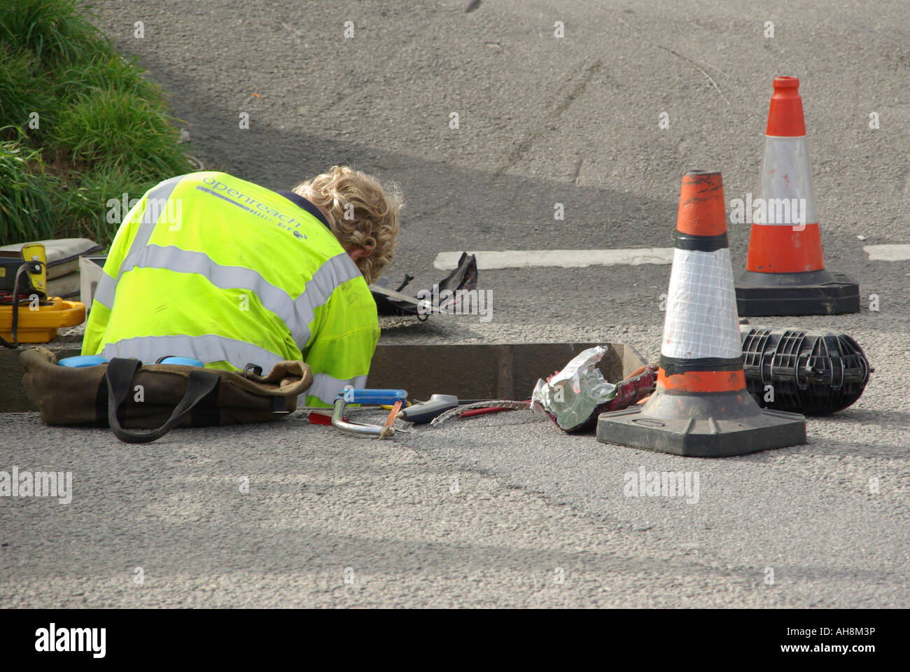 British Telecom engineer sitting in road manhole working on underground ... British Telecom engineer sitting in road manhole working on underground ...