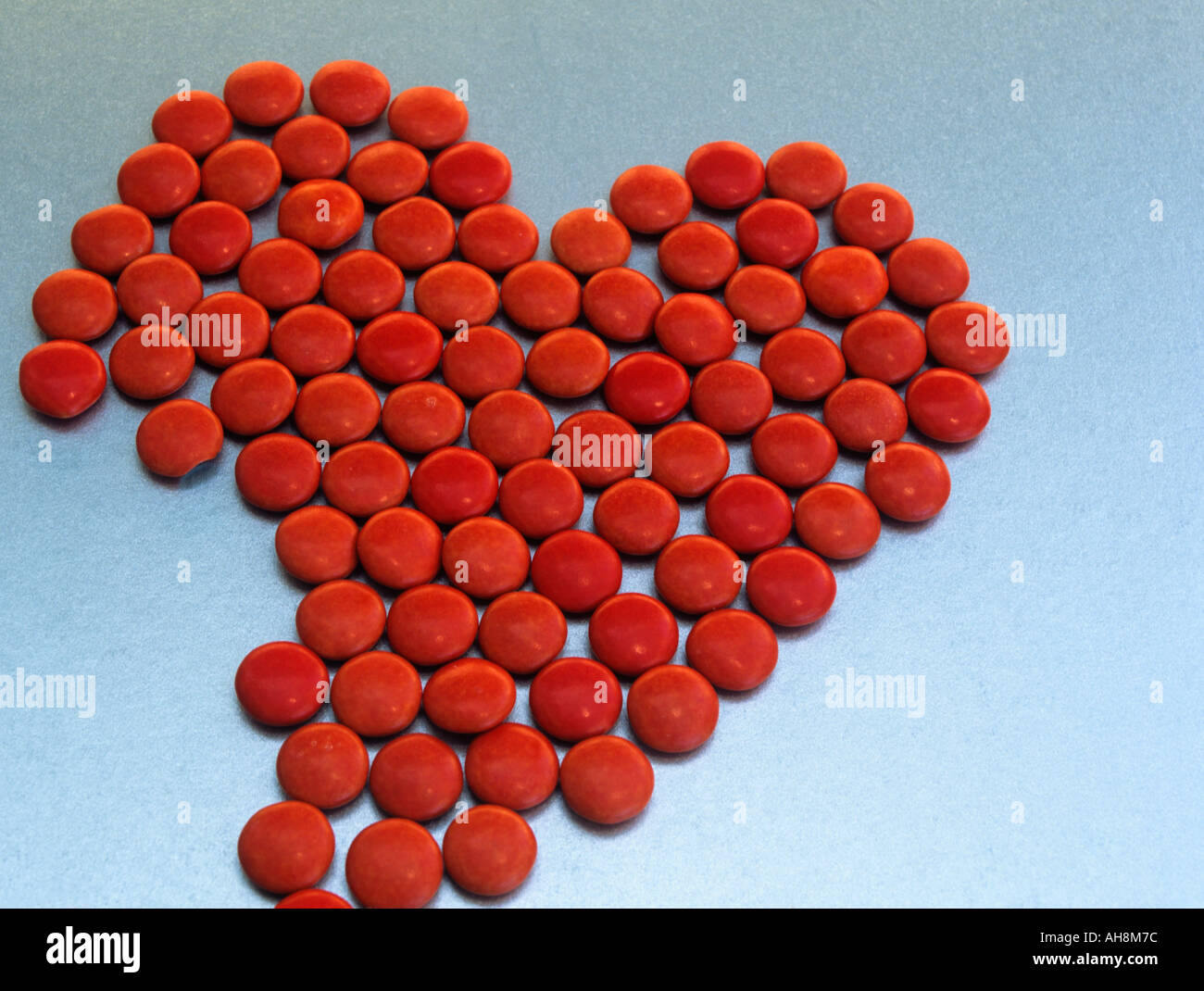 STUDIO STILL LIFE CONCEPT ABSTRACT Red coloured sweets arranged in such ...