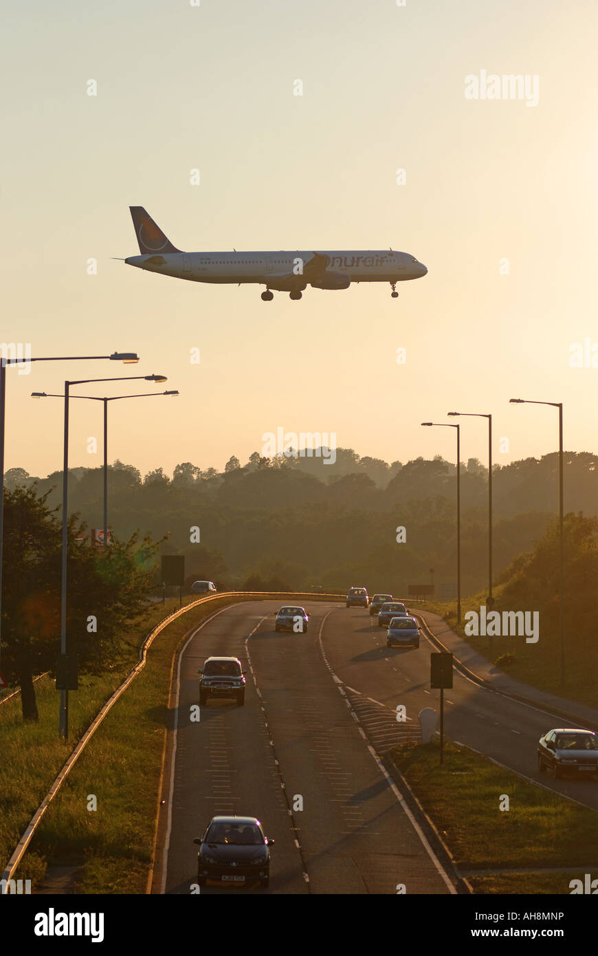 Onur Air Airbus A321 aircraft crossing A45 road at sunset to land at ...