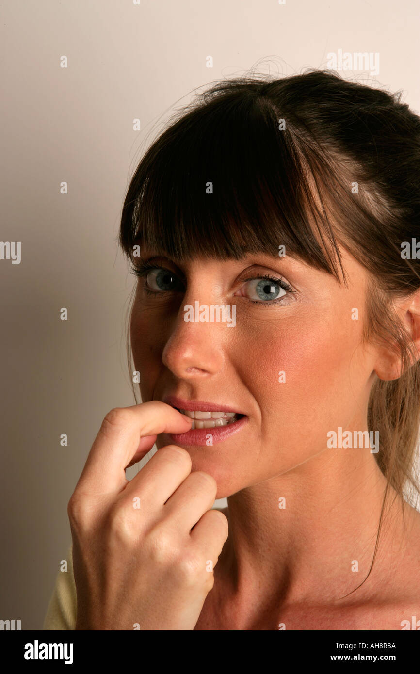 Struggle woman biting nails hi-res stock photography and images - Alamy
