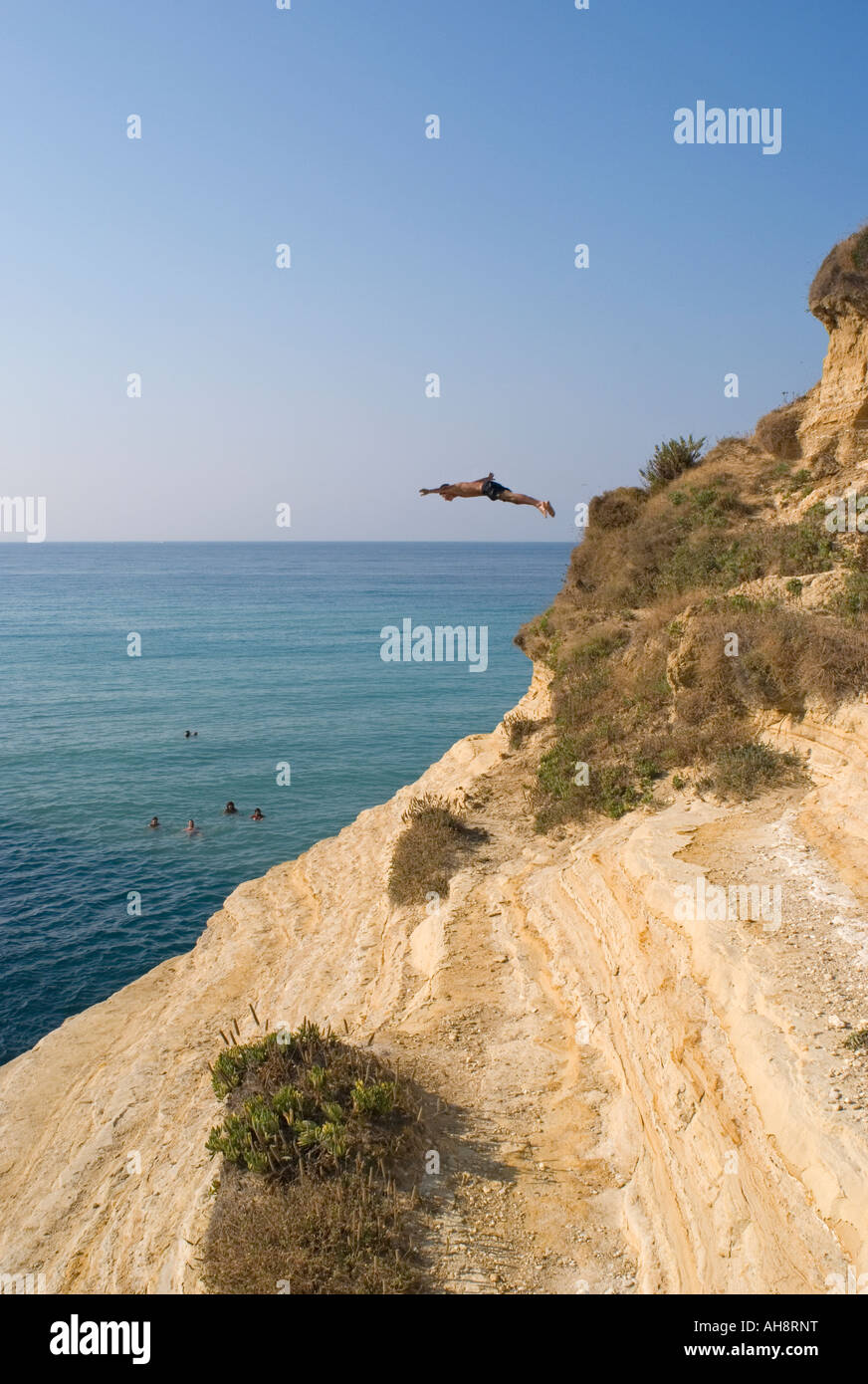 Young man jumping from a cliff hi-res stock photography and images - Alamy