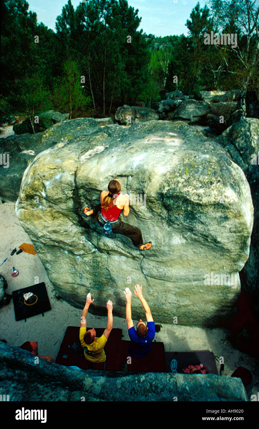 Lucy Creamer on a high boulder problem in Fontainbleau France Stock ...