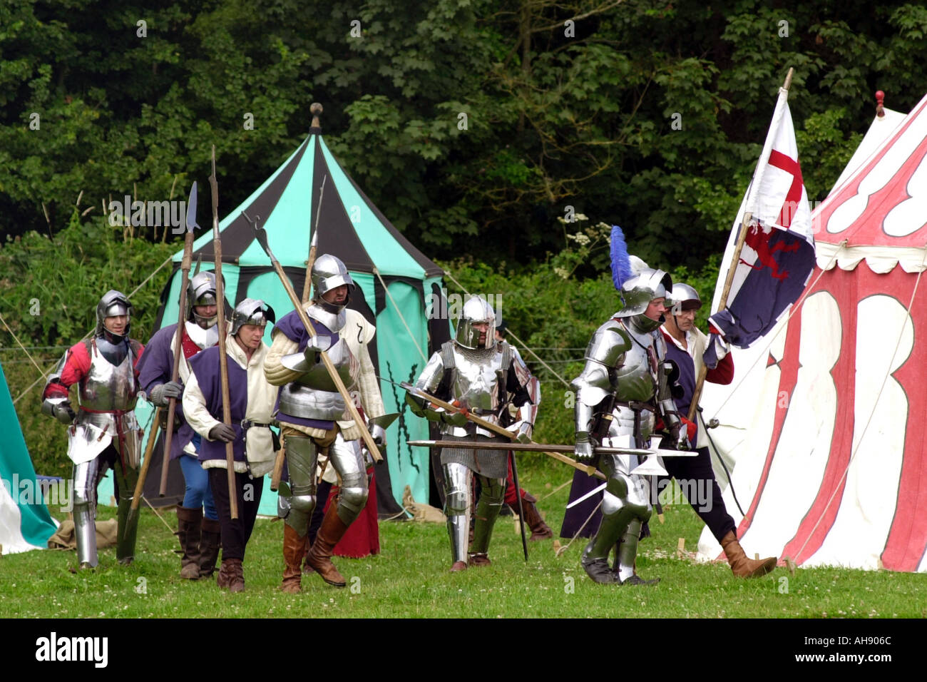 Knights in armour march from encampment at re enactment of a medieval ...