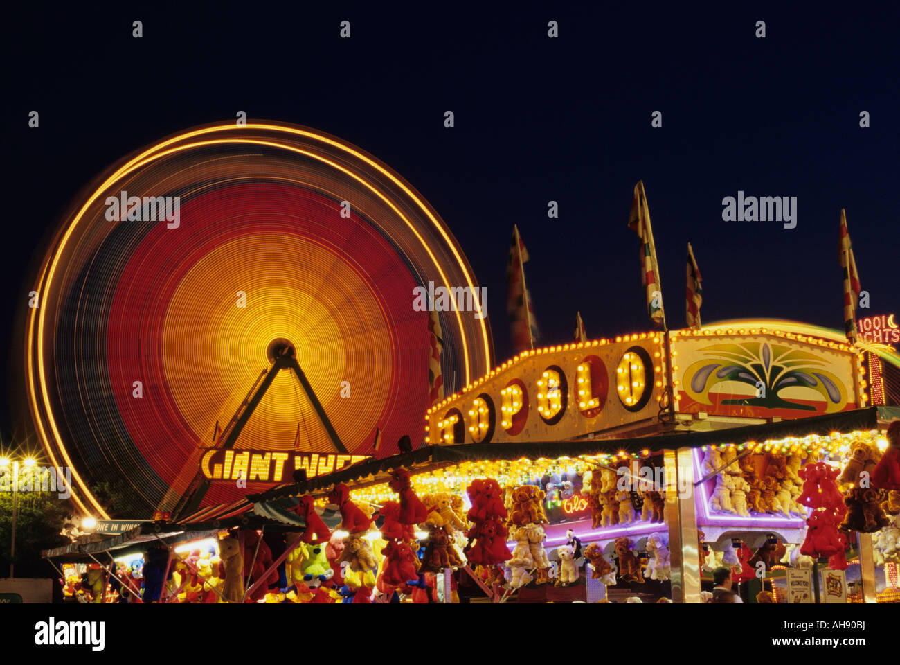Evergreen State Fair amusement rides and game booths at night with ...