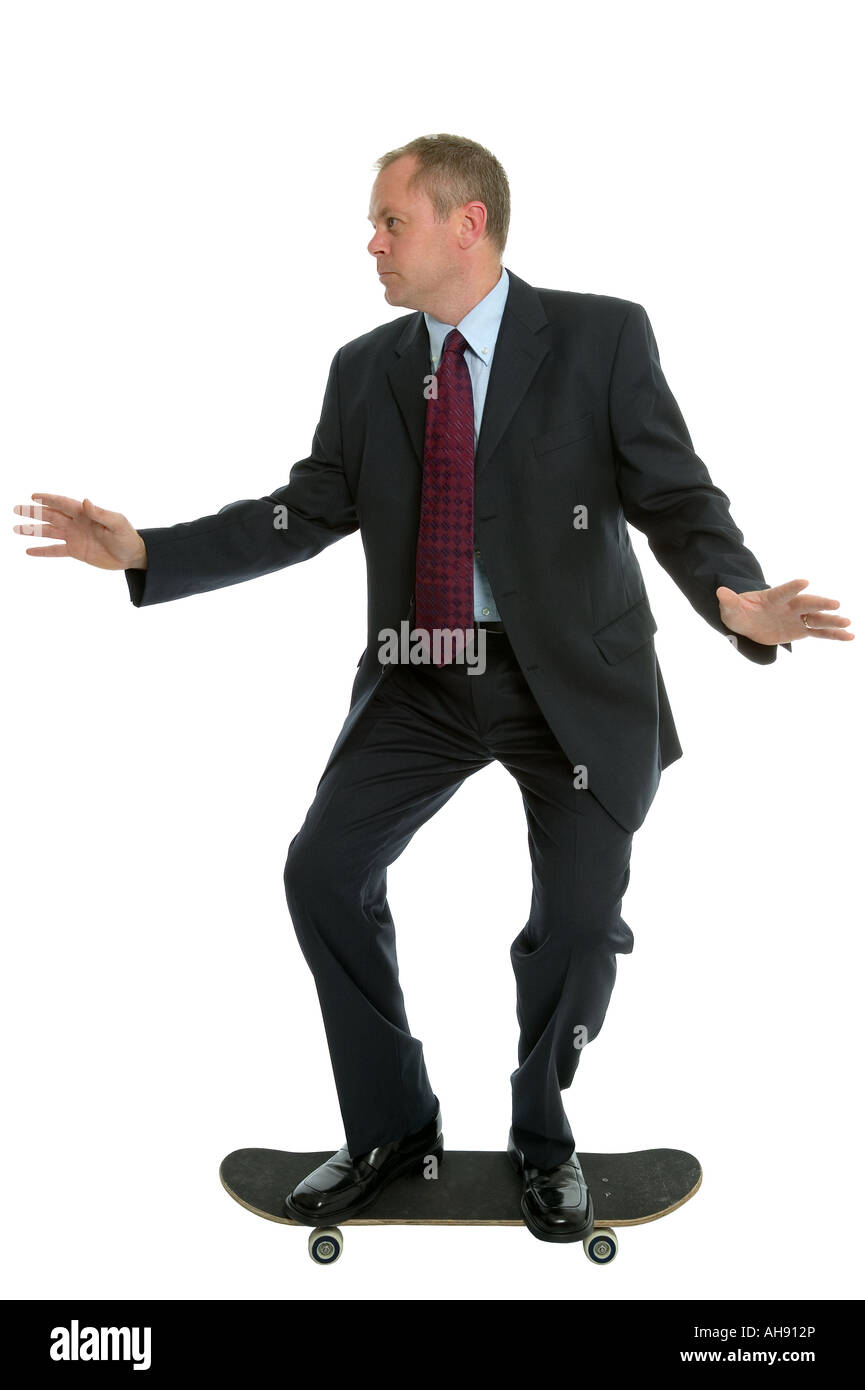 Businessman riding a skateboard to work Stock Photo - Alamy