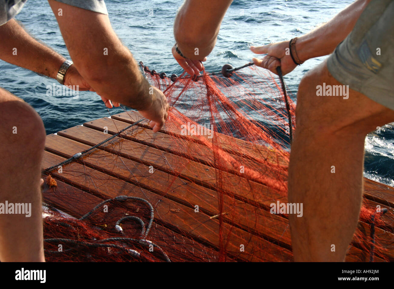 Men pulling a net Stock Photo - Alamy