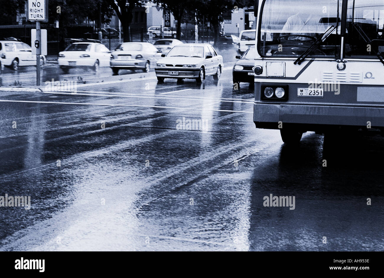 Bus and cars on a wet road after the rain horizontal Stock Photo - Alamy