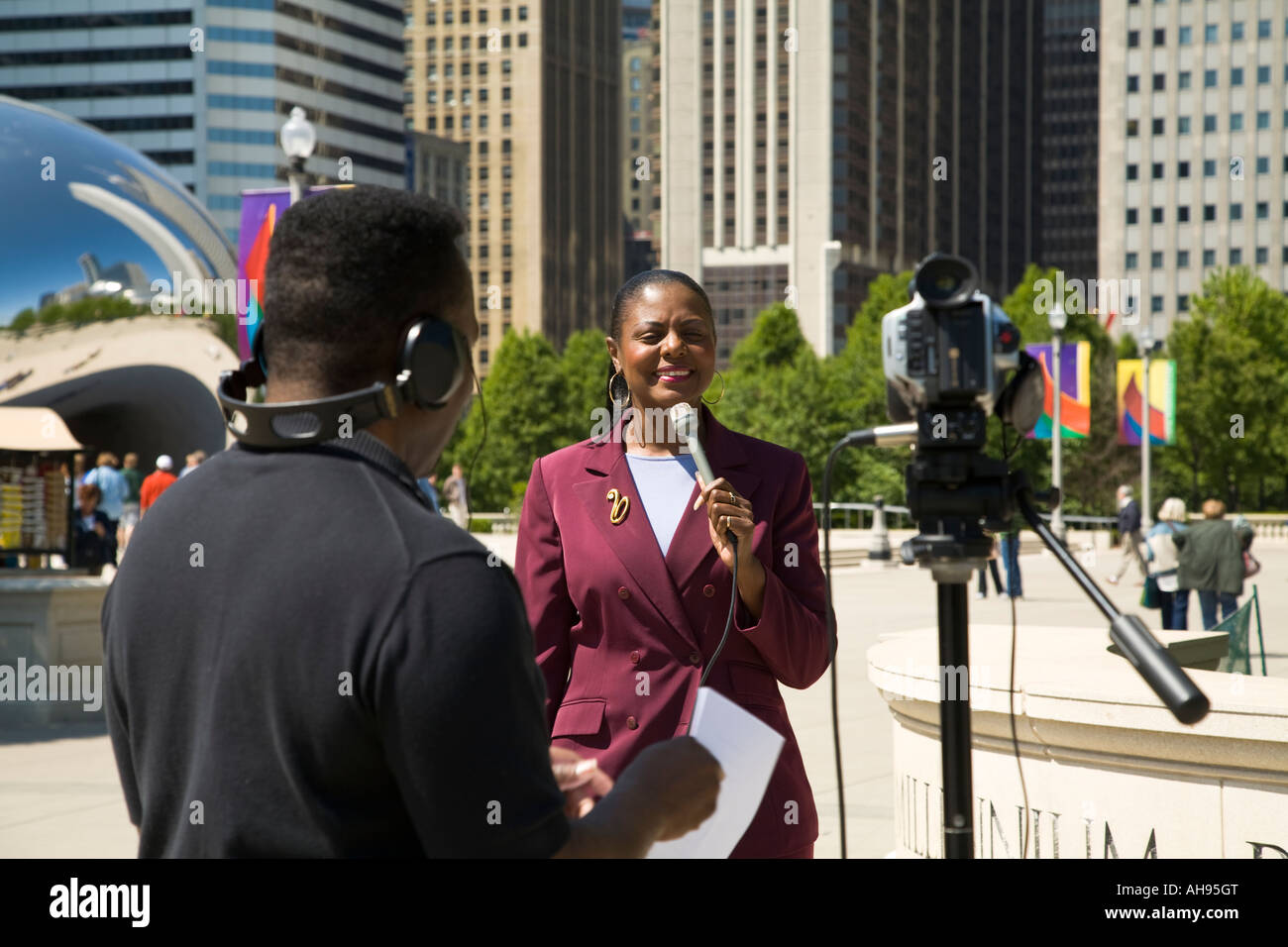 ILLINOIS Chicago Cameraman with video camera record African American ...