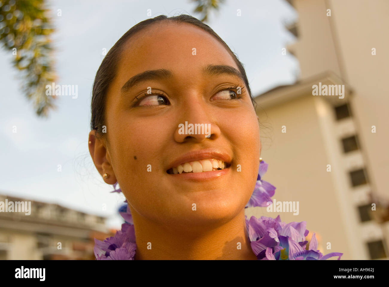 Hawaii Kauai Portrait of Hawaiian woman smiling with purple lei flowers ...