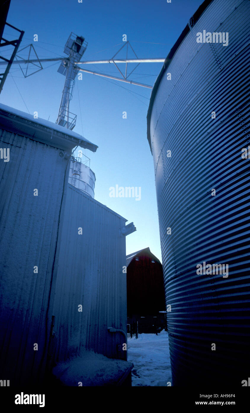 Grain silos at farm with barn in winter Stock Photo - Alamy