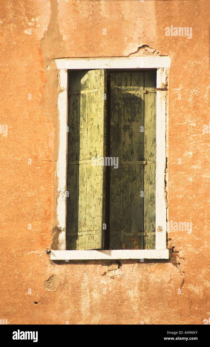 Old window shutters on a colorful venetian wall in Venice, Italy Stock ...