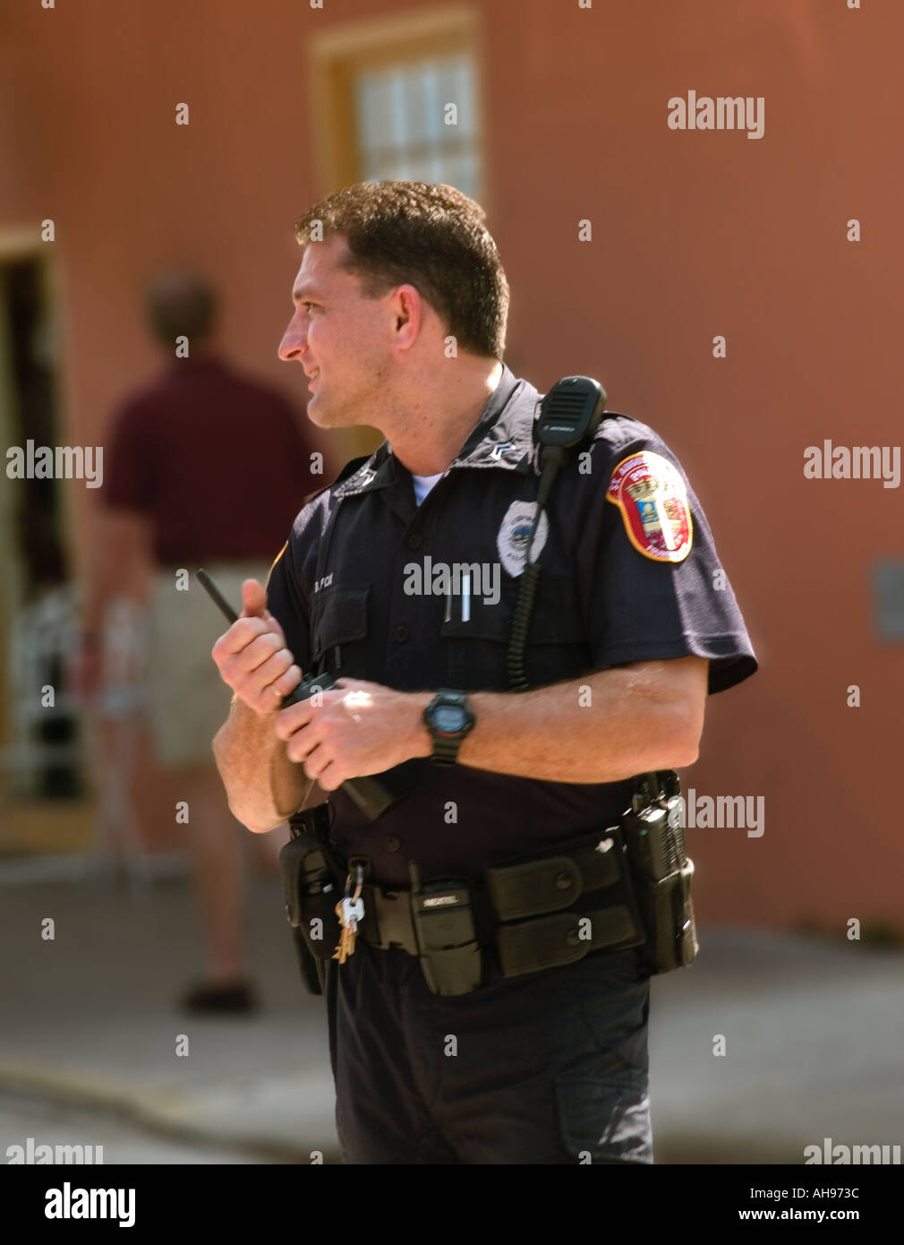 Young Caucasian male police officer patrolling neighborhood, USA Stock ...