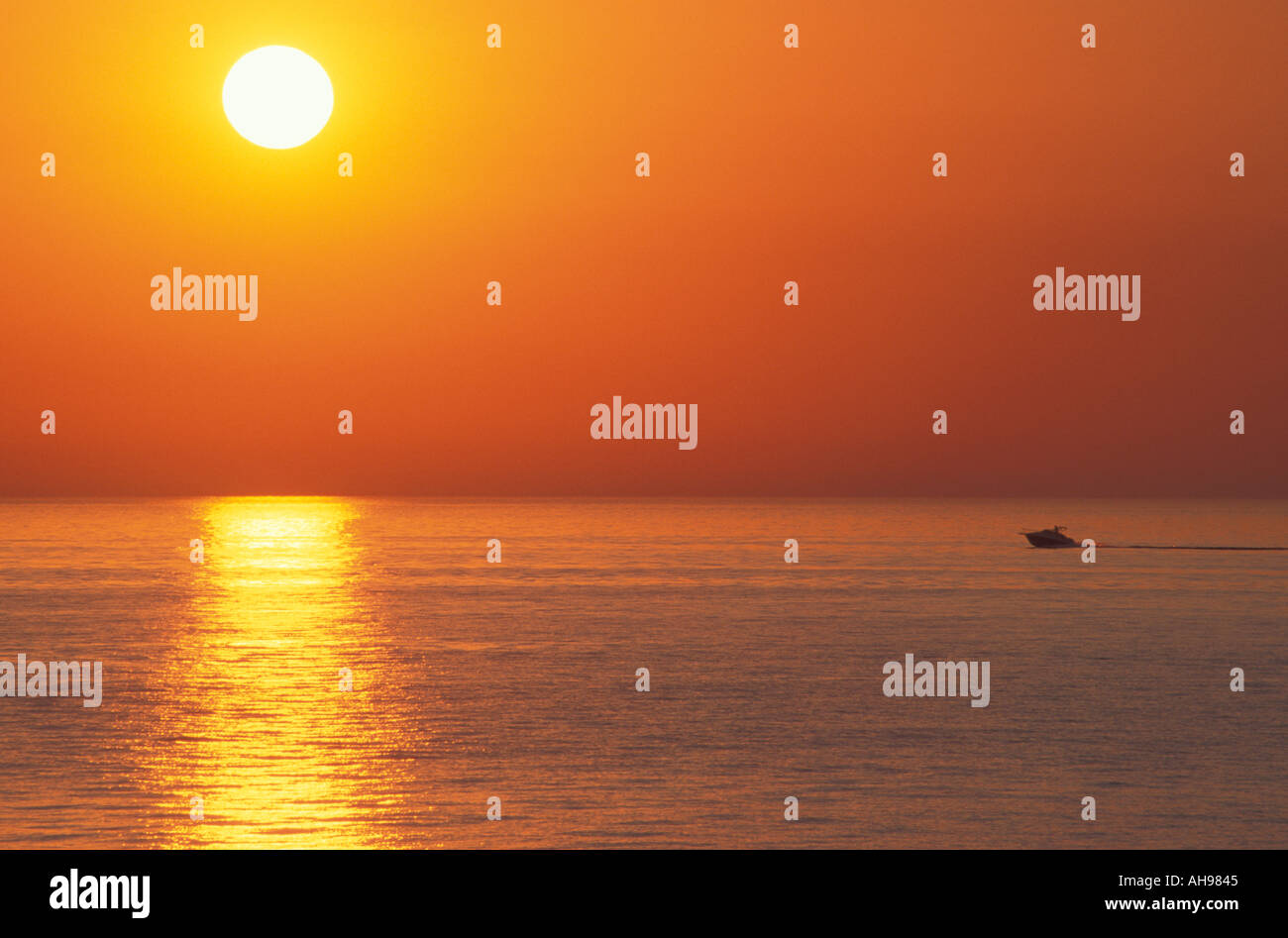 Boating at sunset Stock Photo - Alamy