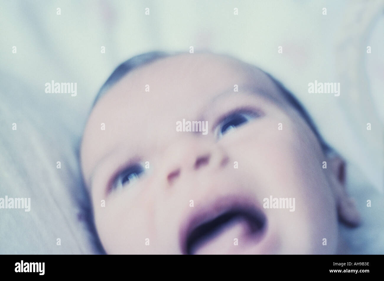 Four week old baby boy of mixed race crying Stock Photo - Alamy