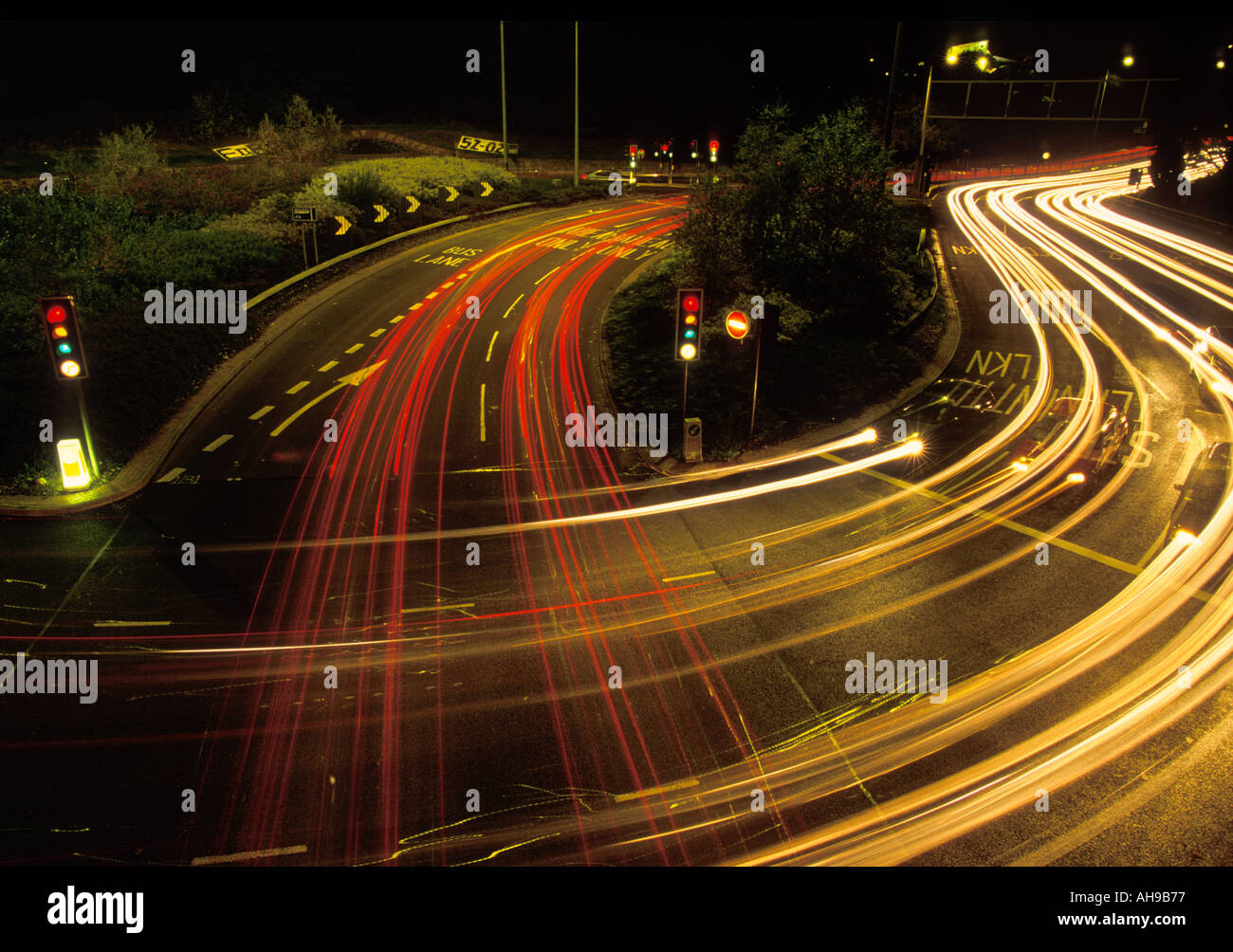 Light trails caused by traffic at a busy road junction with traffic ...
