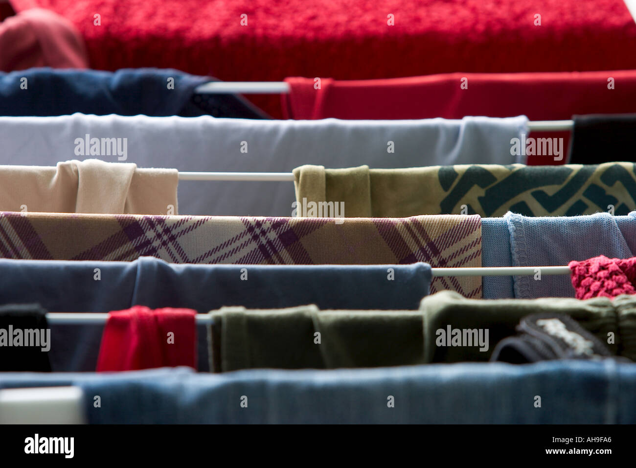 Piece of several clothes hanging on washing rack Stock Photo - Alamy