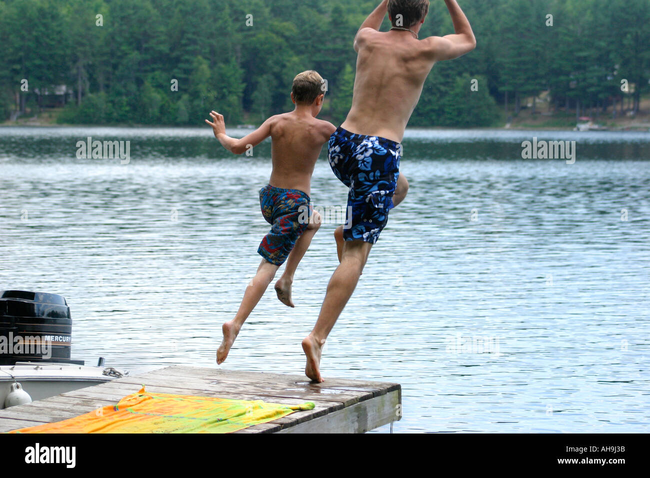 Boys Jumping Off Dock Stock Photo - Alamy