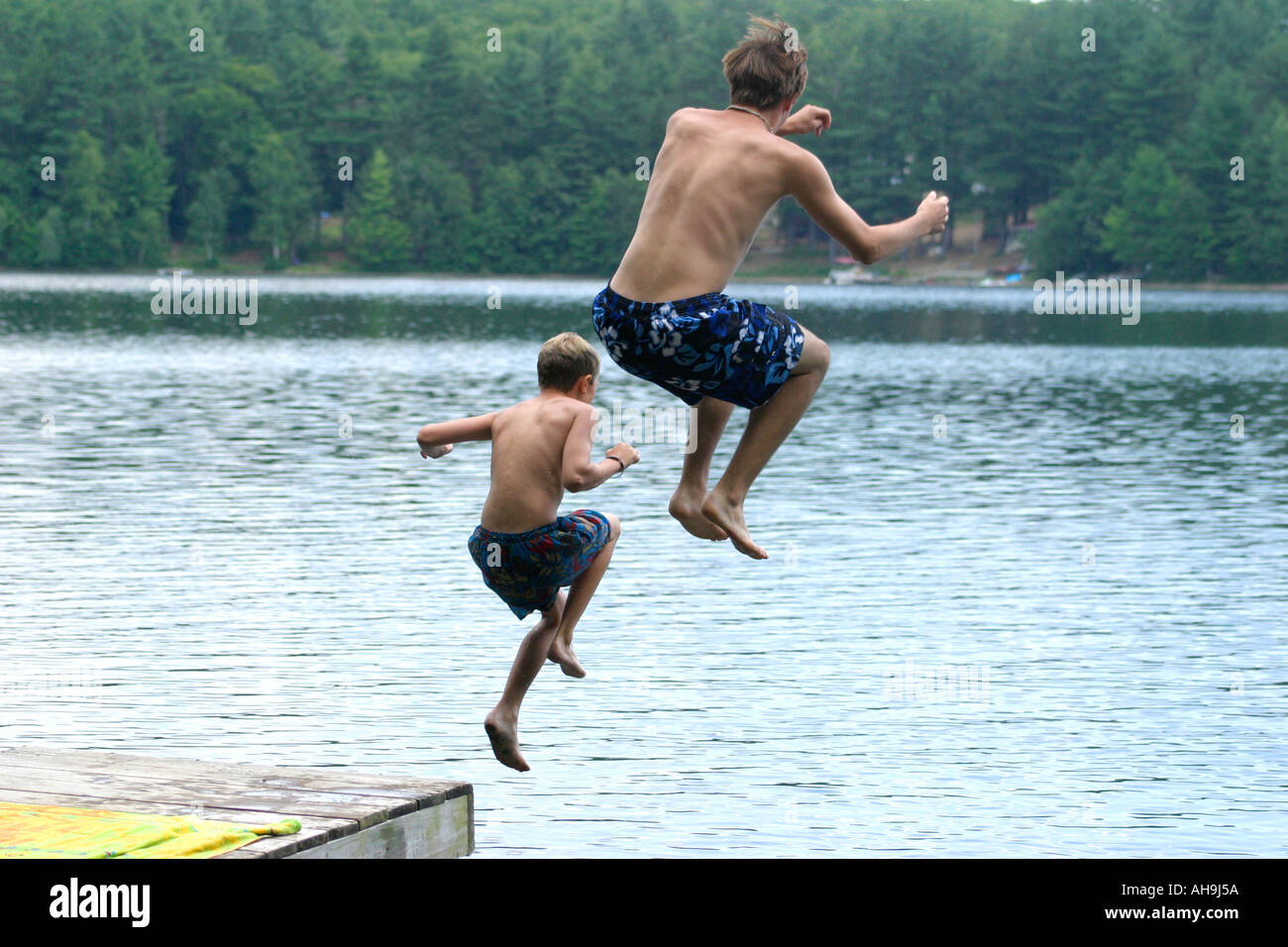 Boys Jumping Off Dock Stock Photo - Alamy