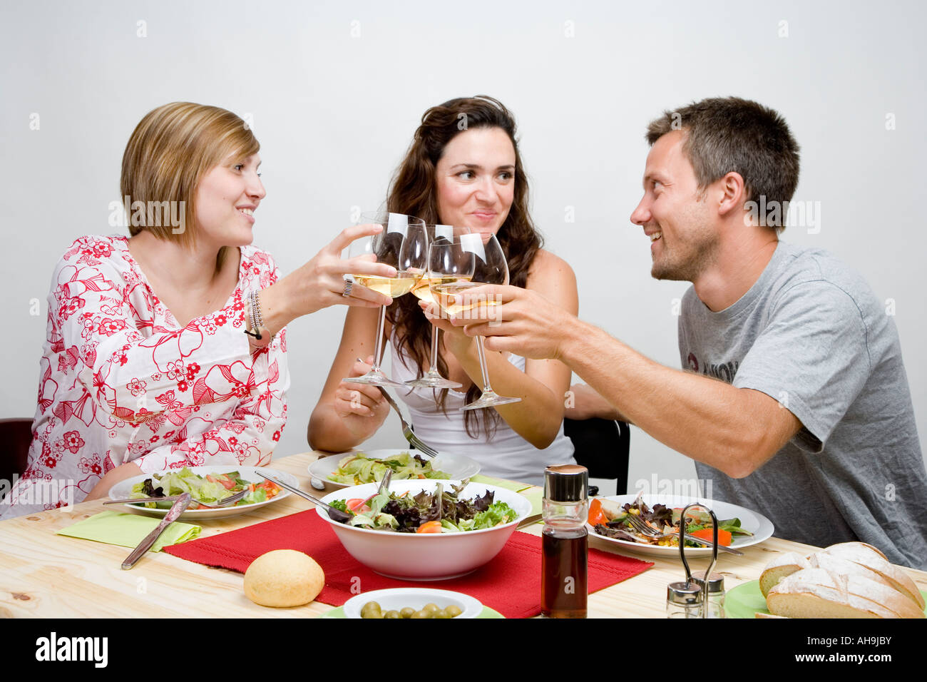 young people drinking a toast Stock Photo - Alamy